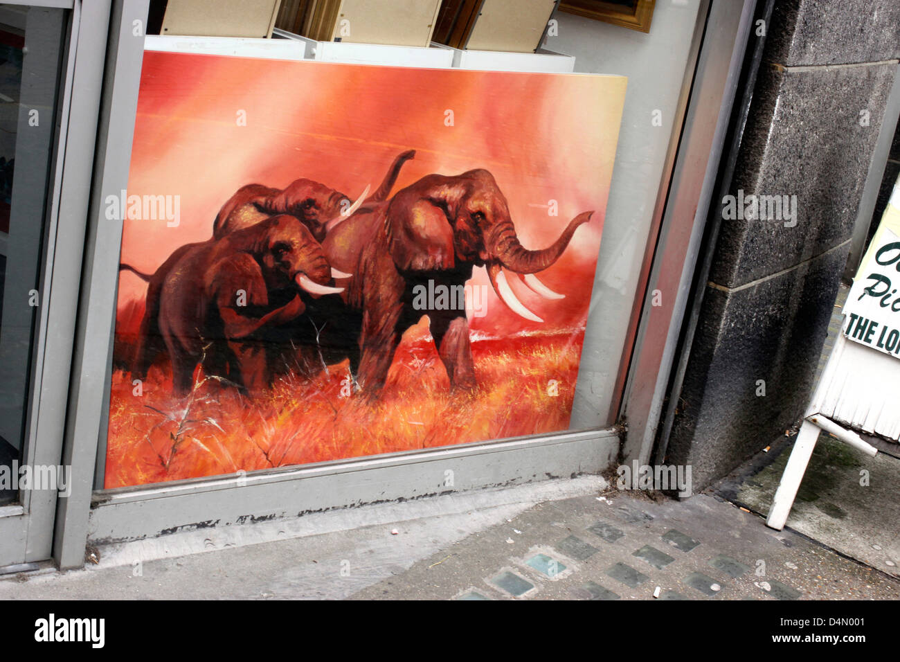 A painting of elephants on display in a frame shop in London Stock ...