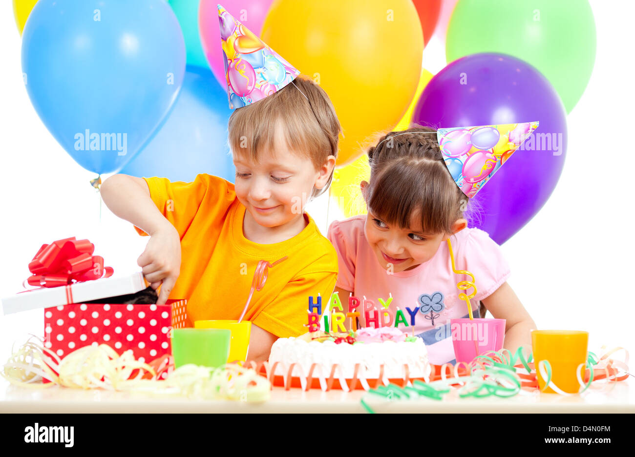 adorable children celebrating birthday party and opening gift box Stock ...
