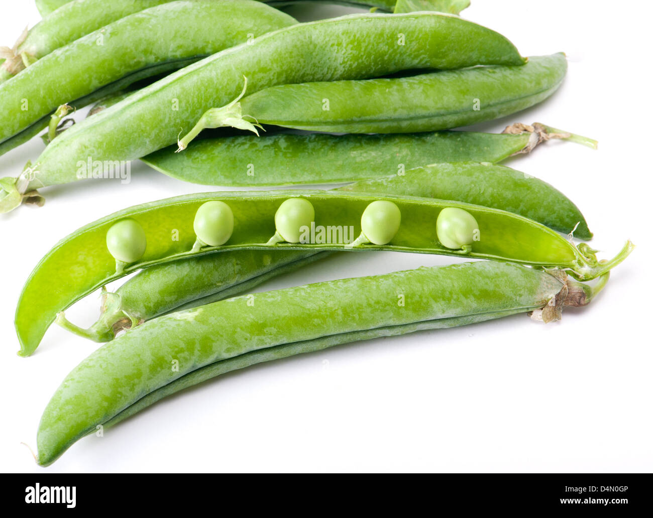 Green peas isolated on a white background Stock Photo - Alamy