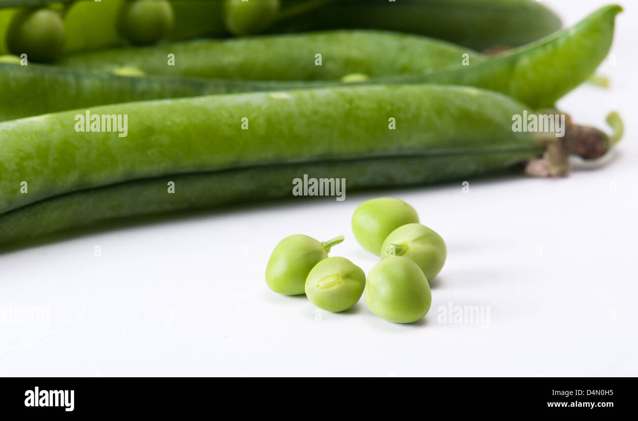 Green peas isolated on a white background Stock Photo - Alamy