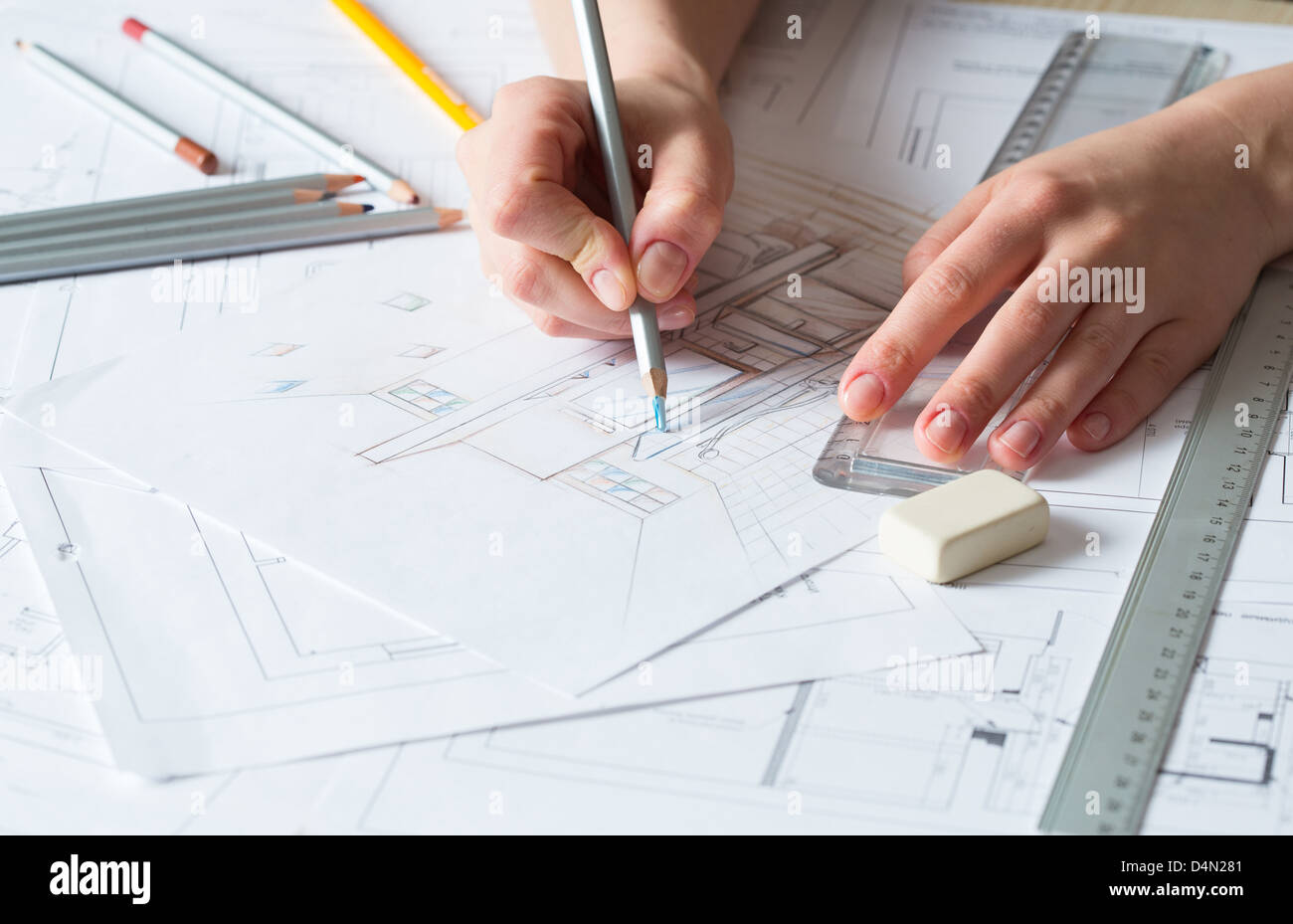 Interior designer works on a hand drawing sketch using color pencils ...