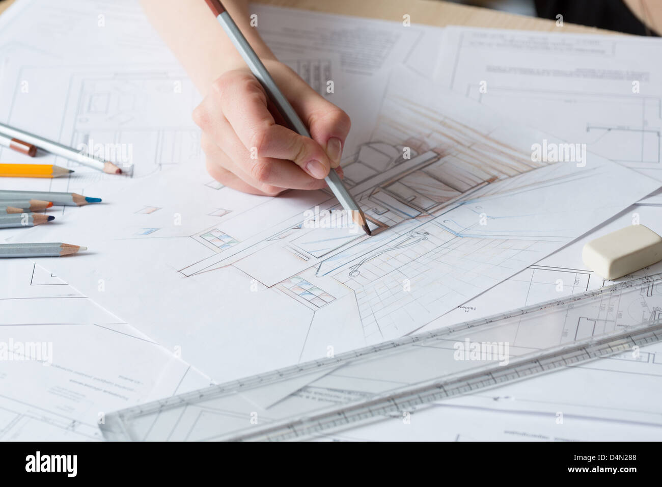 Interior designer works on a hand drawing sketch using color pencils ...