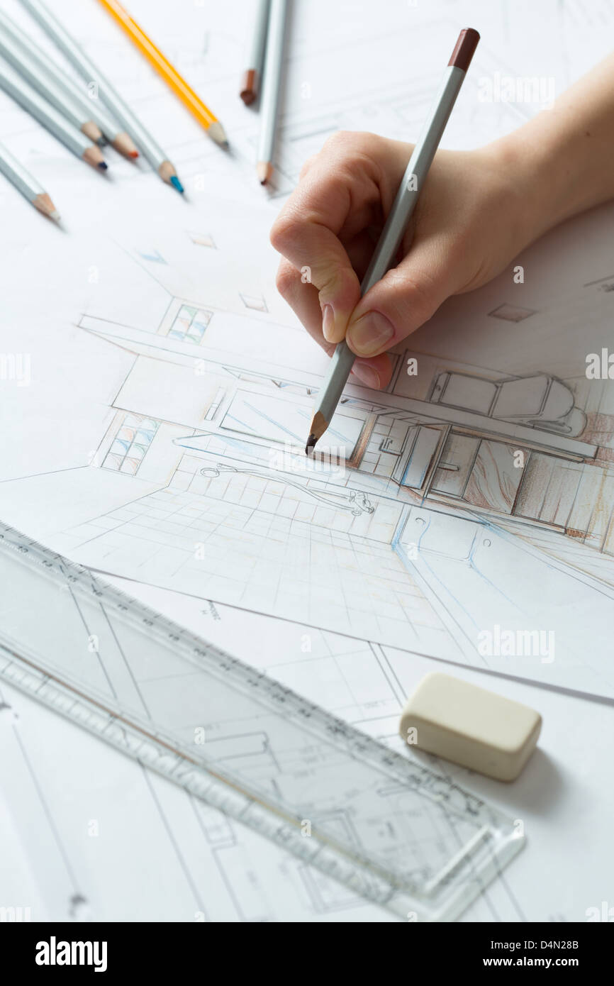 Interior designer works on a hand drawing sketch using color pencils ...