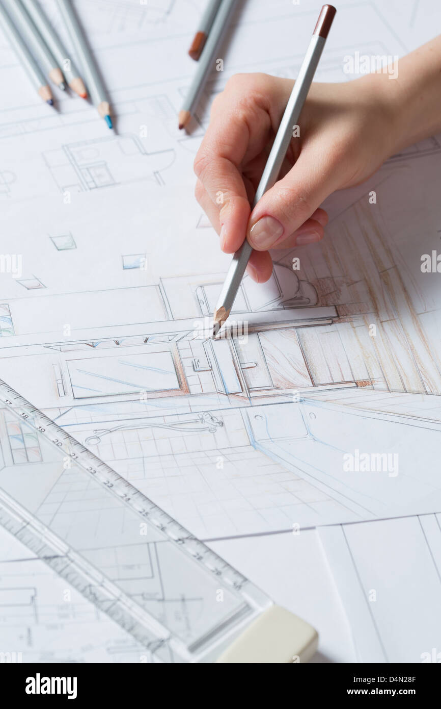 Interior designer works on a hand drawing sketch using color pencils ...