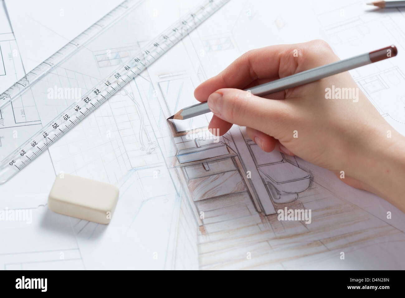 Interior designer works on a hand drawing sketch using color pencils ...