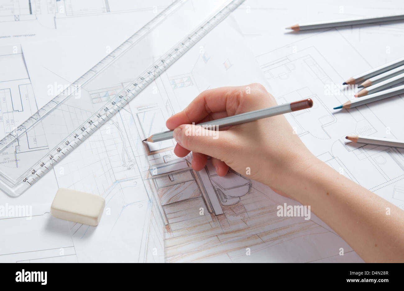 Interior designer works on a hand drawing sketch using color pencils ...