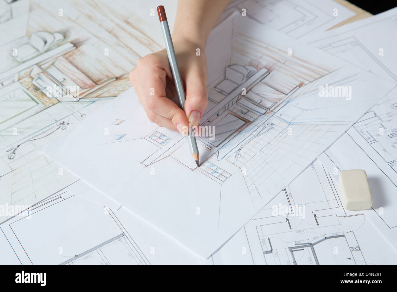 Interior designer works on a hand drawing sketch using color pencils ...