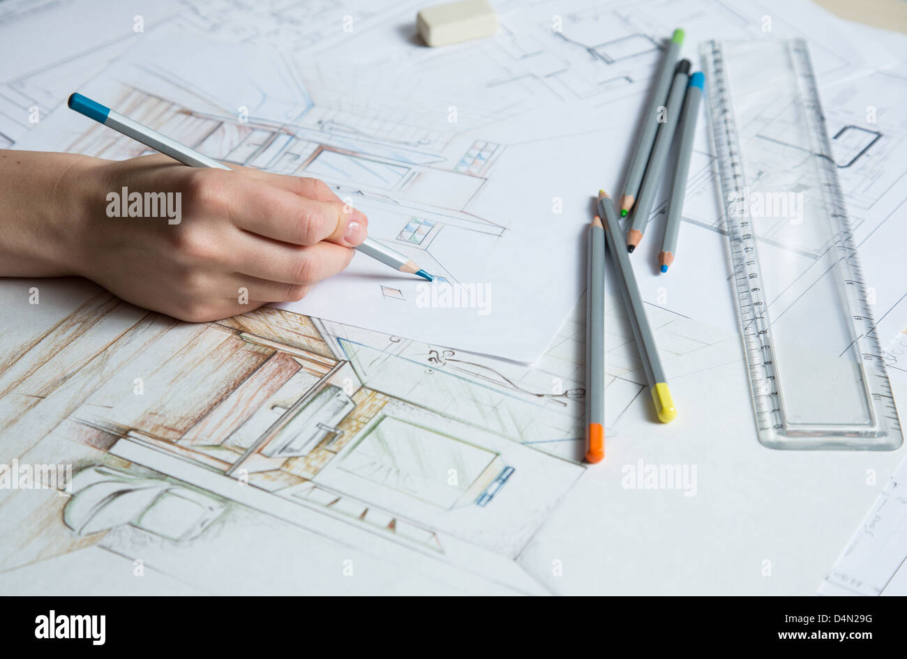 Interior designer works on a hand drawing sketch using color pencils ...