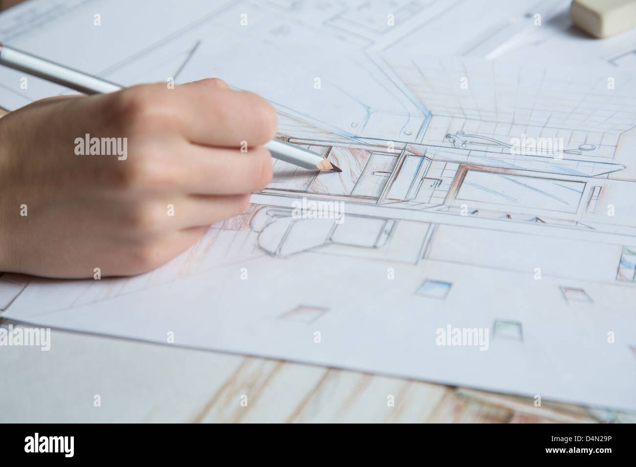 Interior designer works on a hand drawing sketch using color pencils ...