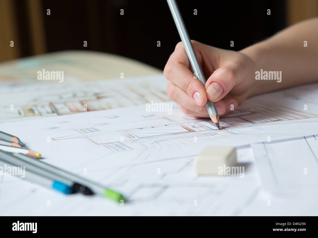 Interior designer works on a hand drawing sketch using color pencils ...