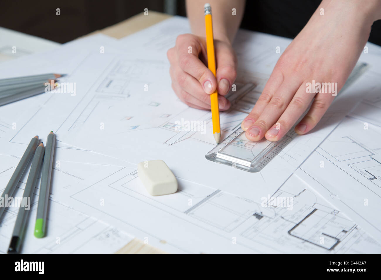 Interior designer works on a hand drawing sketch using color pencils ...