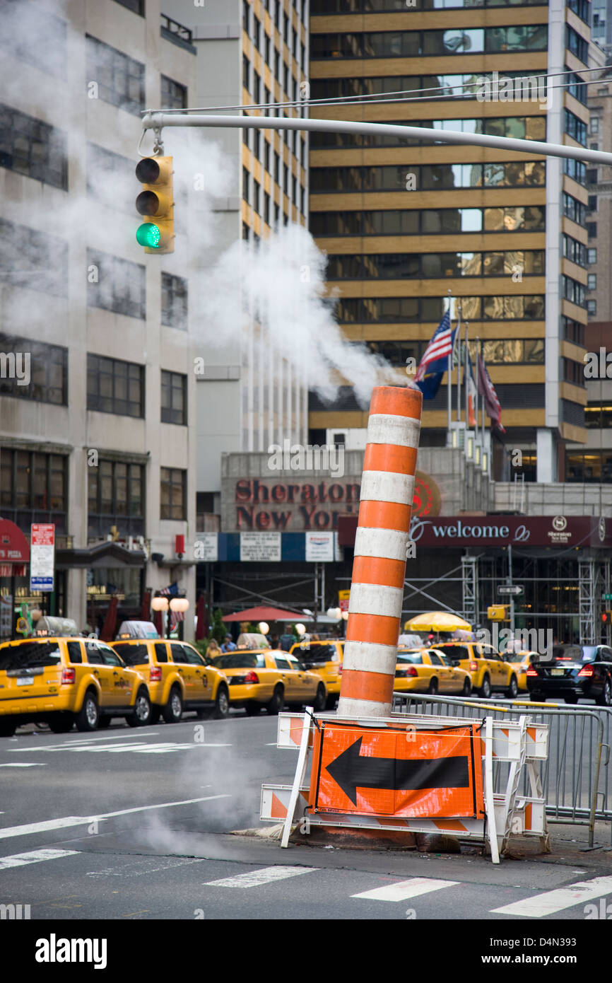 Steam chimney vent in the street in New York Stock Photo - Alamy