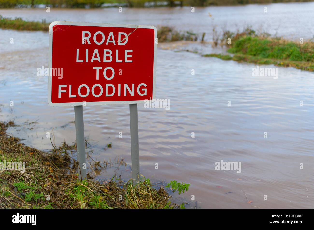 road liable to flooding sign, pictured surrounded by flood water, in ...