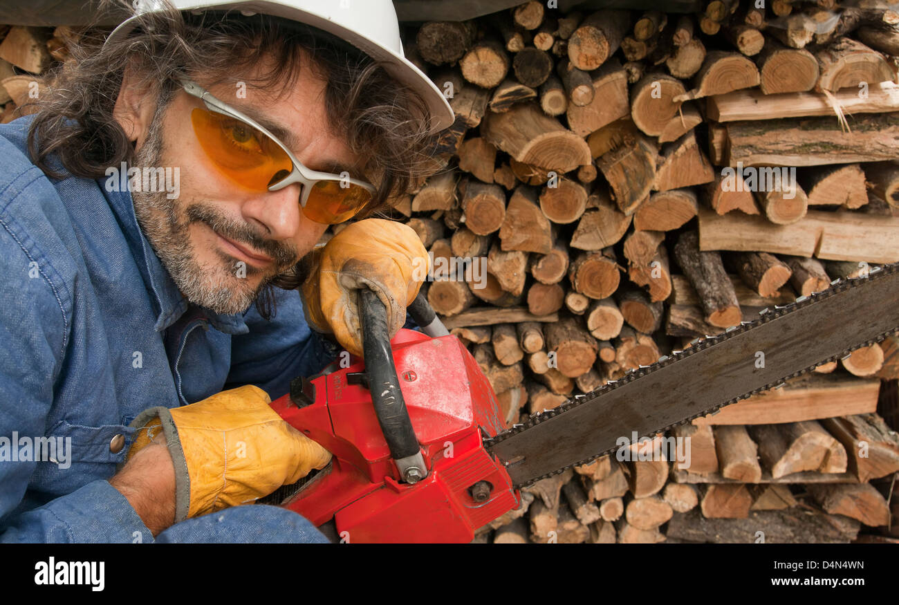 woodcutter with chainsaw looking at camera Stock Photo - Alamy