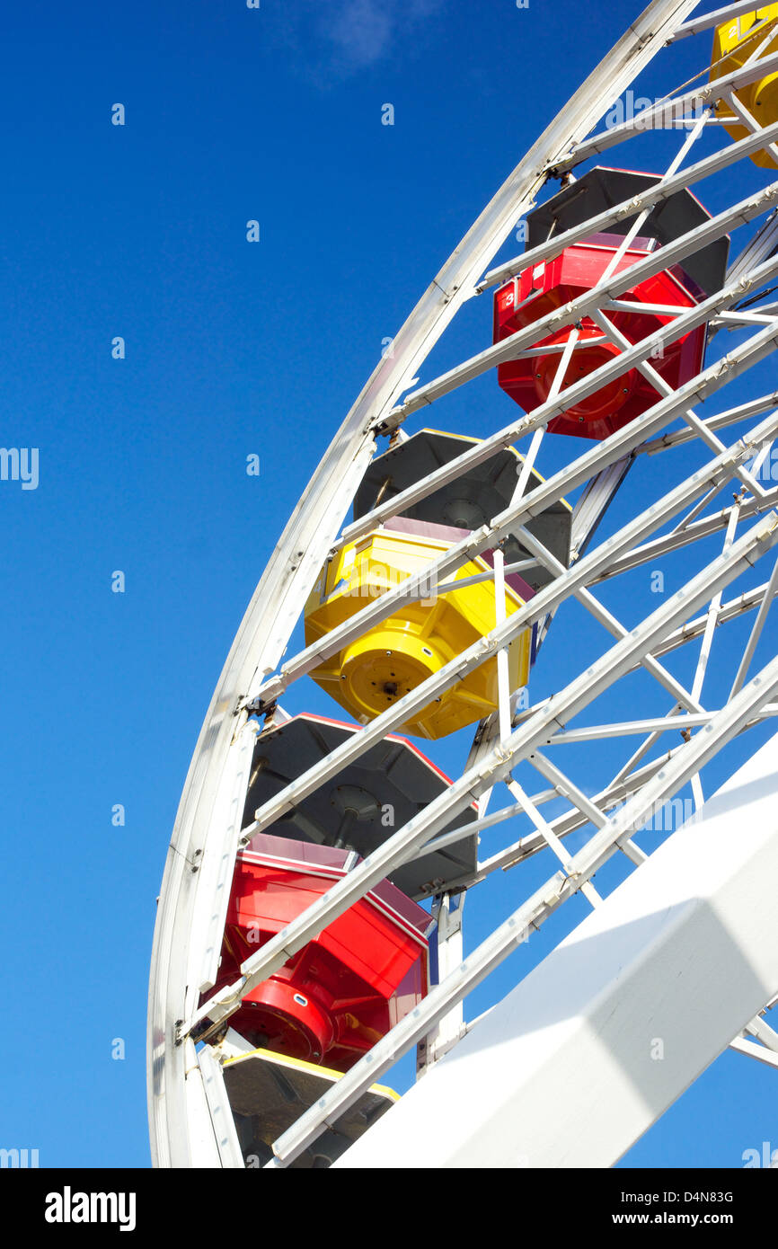 View through the structure of a ferris wheel to the red and yellow ...
