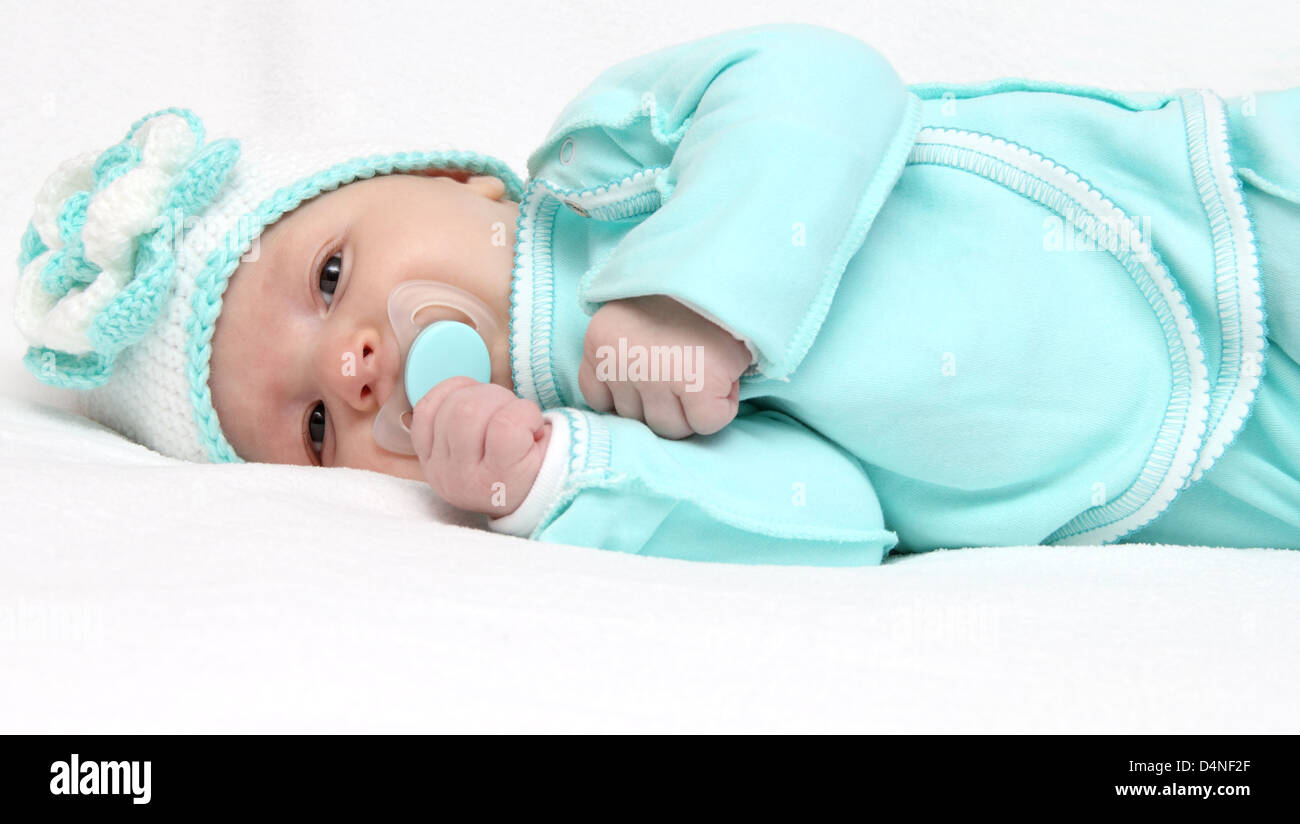 Infant with pacifier looks at the camera Stock Photo - Alamy