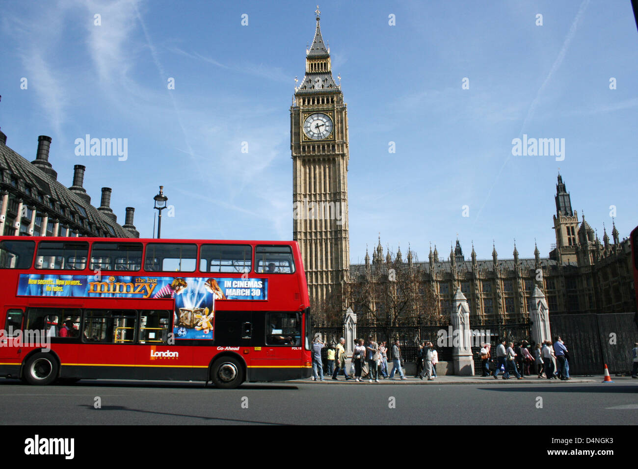 London red bus drives by Big Ben at House of Parliament, London ...