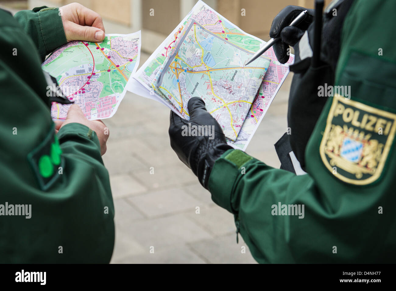 Two police officers check their evacuation plans in Bamberg, Germany ...