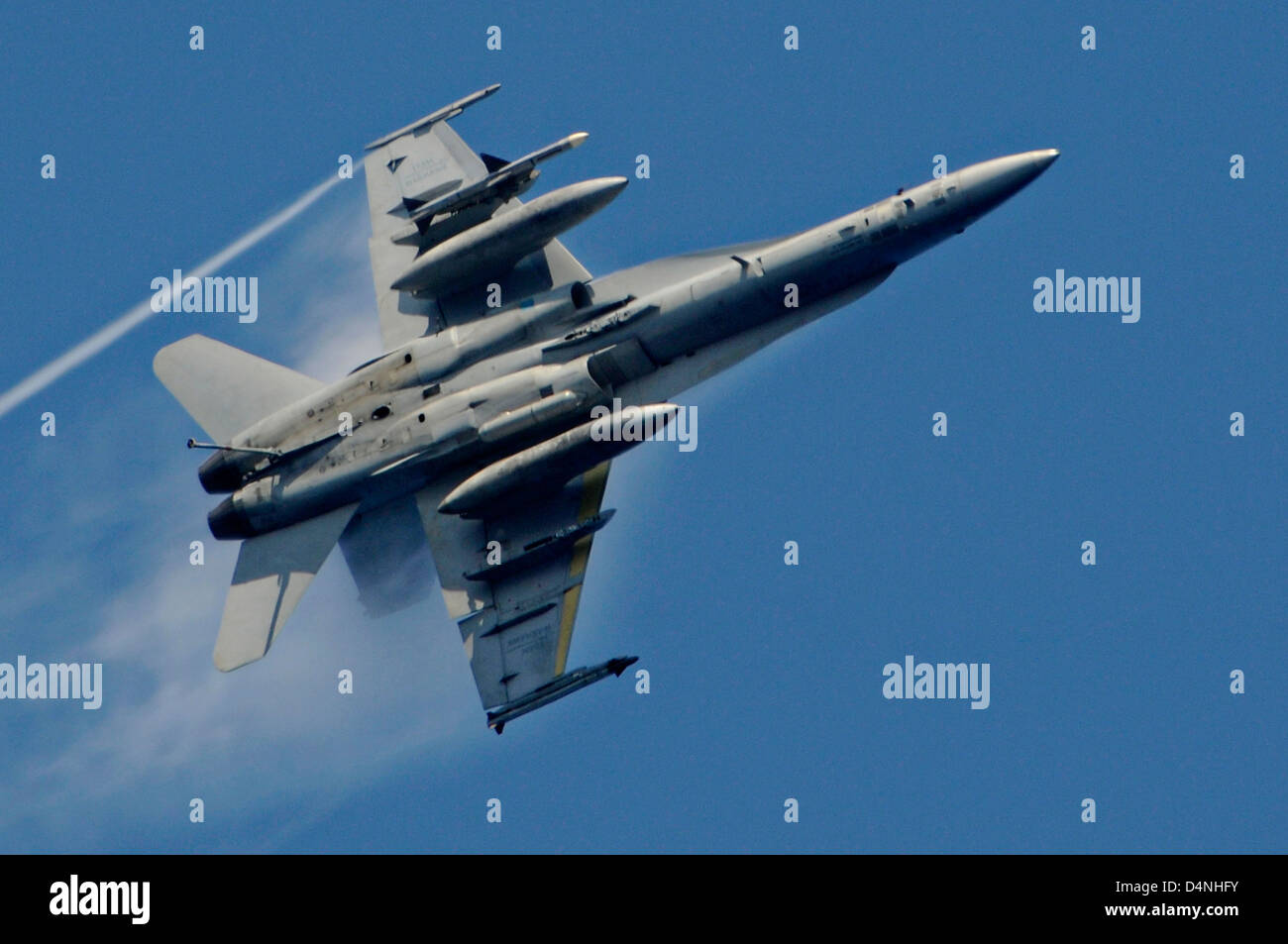 A US Navy F/A-18C Hornet fighter aircraft performs a high speed turn ...
