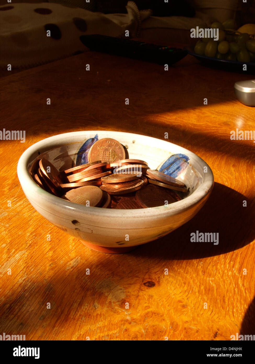 Sunny pot of copper coins Stock Photo - Alamy