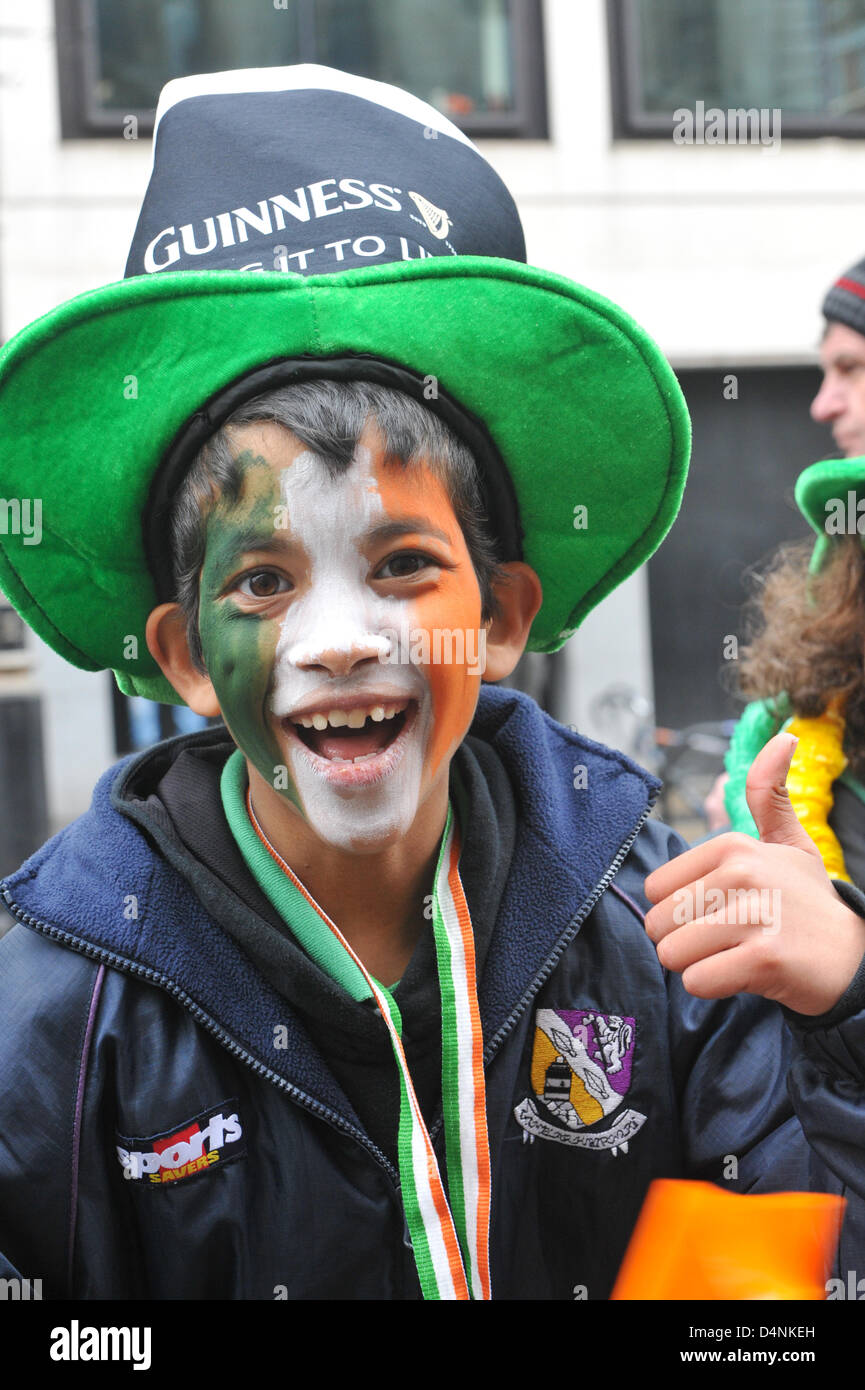 Piccadilly, London, UK. 17th March 2013. A boy in Irish face paint ...