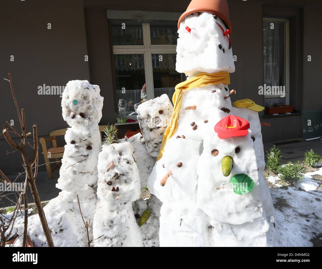 A group of snowmen is pictured in a garden in Berlin, Germany, 17 March ...