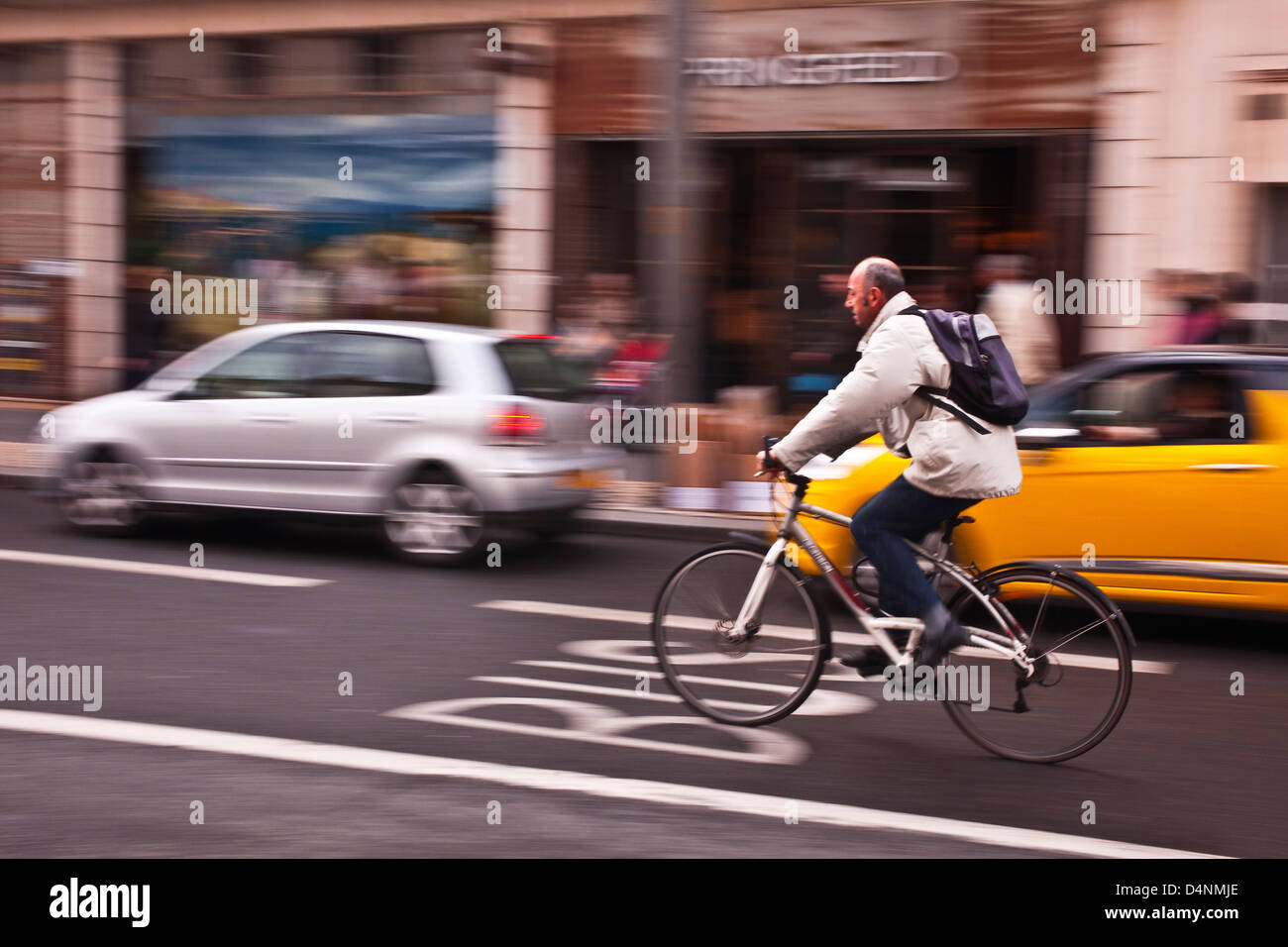 A man cycles quickly down a busy street in Tours, France. The French ...