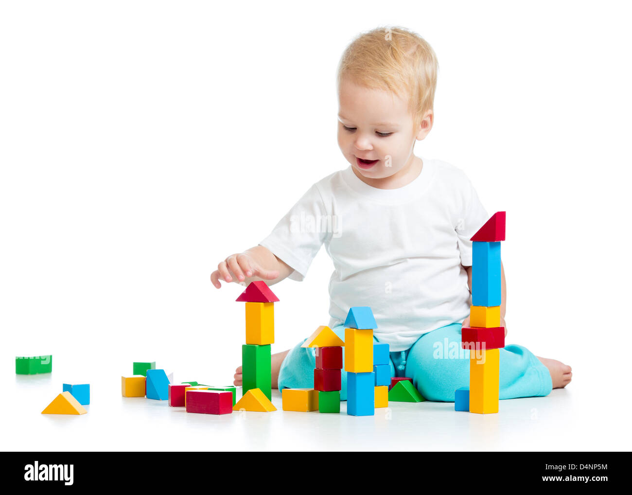 Joyful baby girl playing toy blocks isolated on white background Stock ...