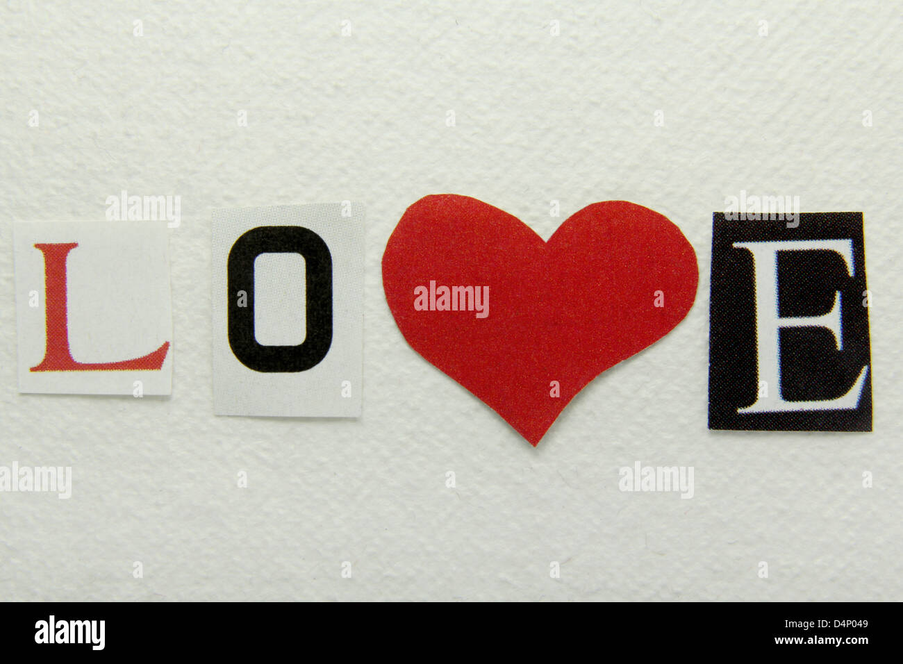 word love cut from newspaper on handmade paper Stock Photo - Alamy