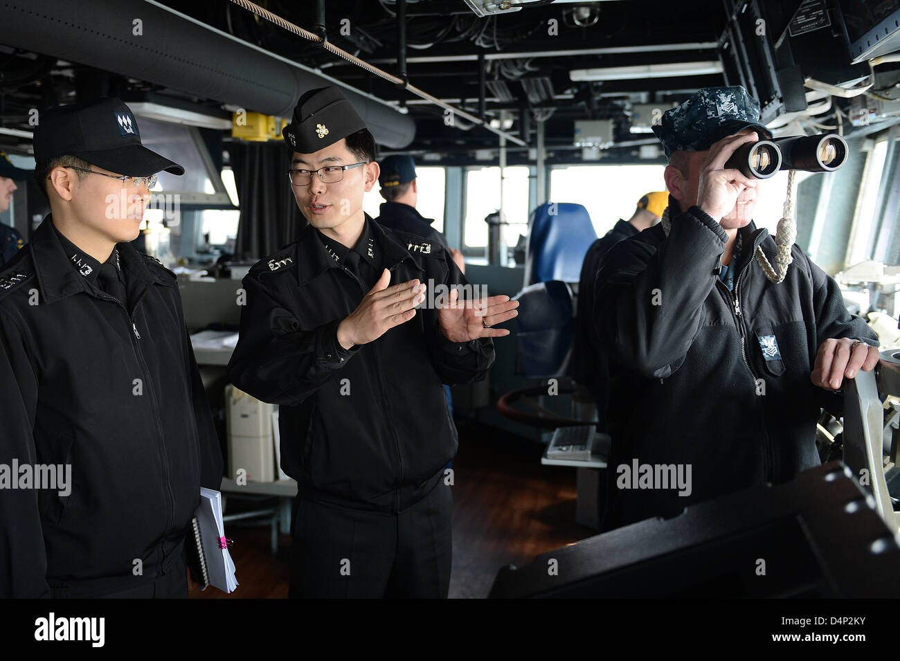 South Korean sailors observe US sailors in the pilot house of the ...