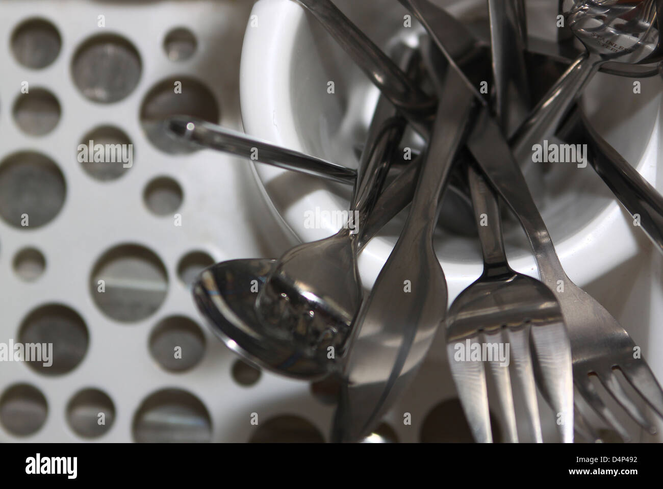 Cutlery drying in plastic rack Stock Photo - Alamy
