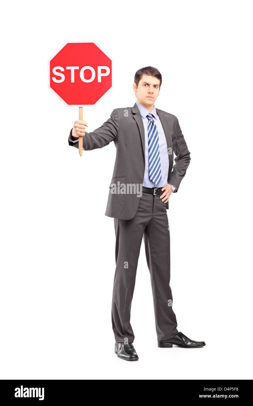 Full length portrait of a businessman holding a stop sign isolated ...