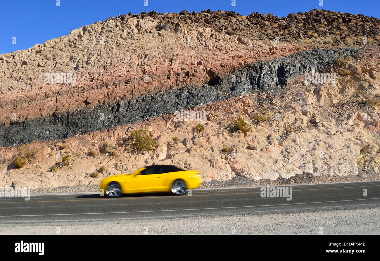 Nevada desert highway with racing stripe on landscape and car. Along ...