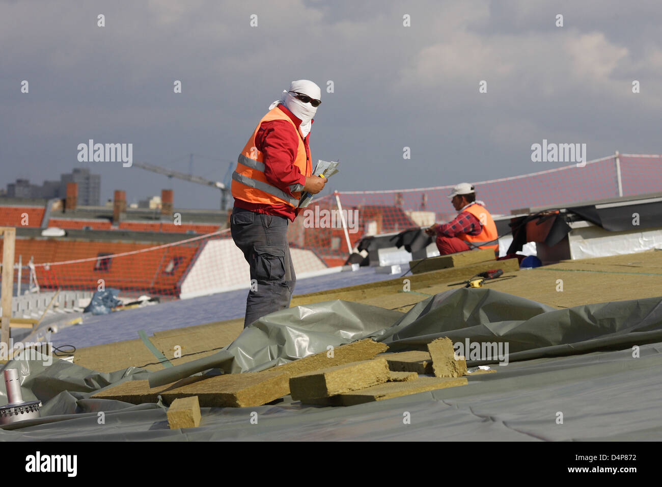 Berlin, Germany, construction worker lays insulation batts Stock Photo ...