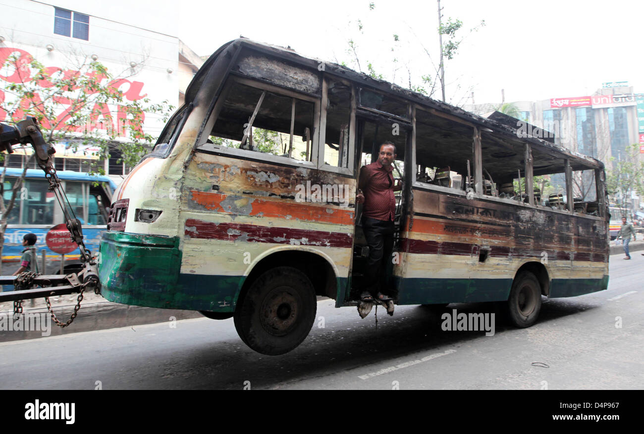 March 17, 2013 - Dhaka, Bangladesh - A Police van tows a burnt bus from ...