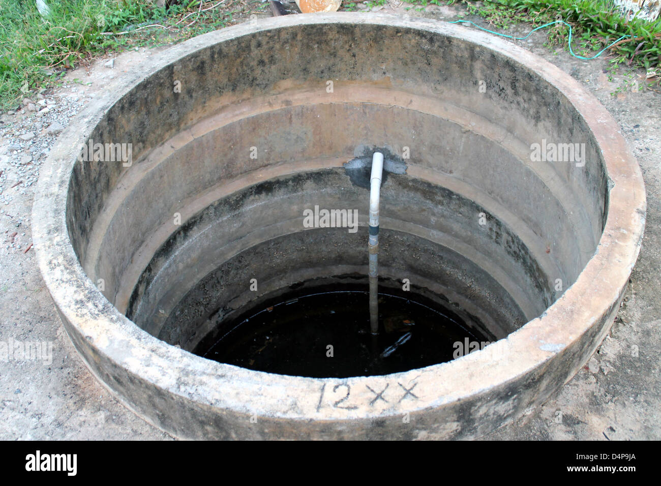 A small well with water pump connected Stock Photo - Alamy