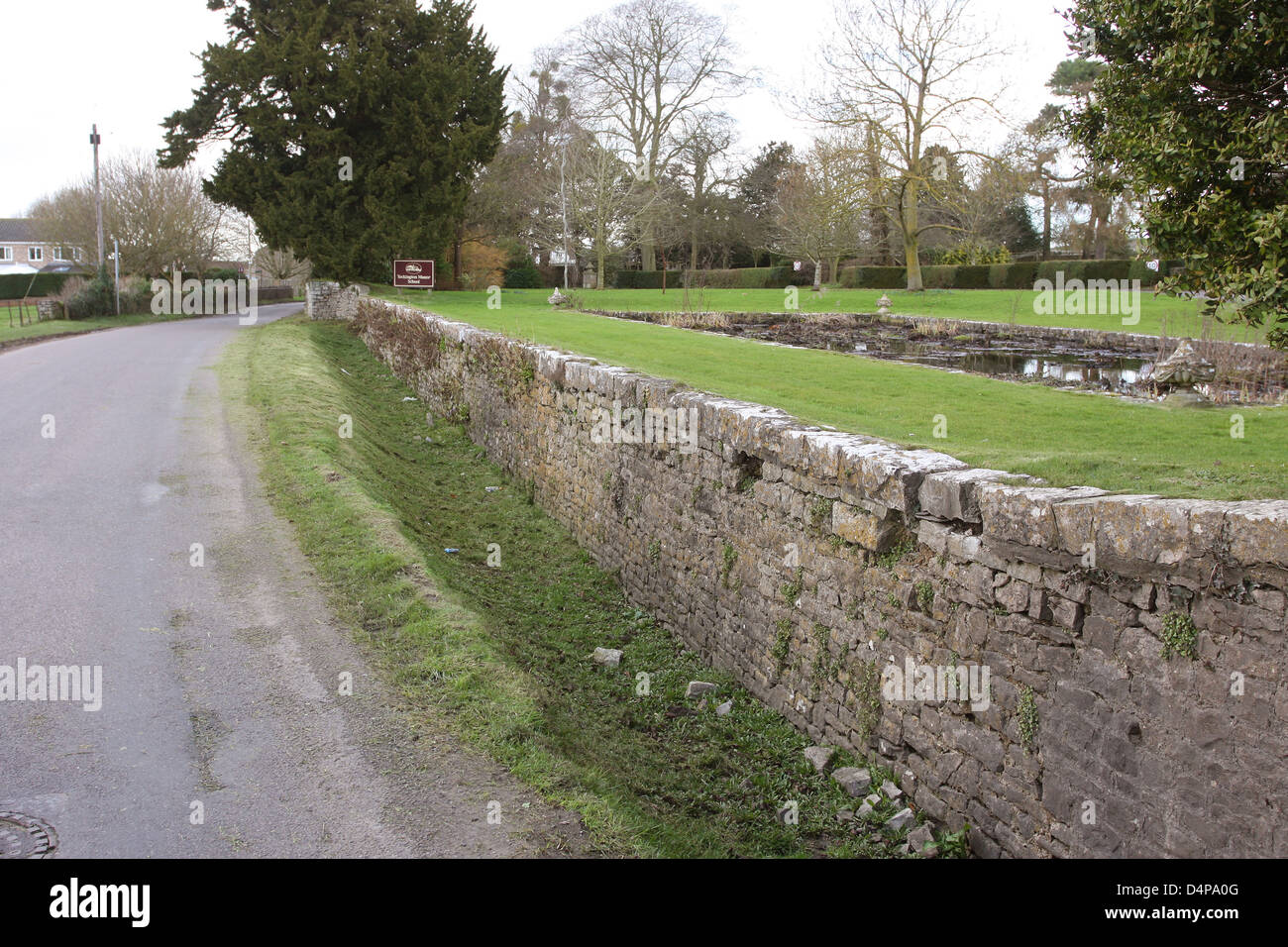 Quiet rural road with stone wall and drainage ditch Stock Photo - Alamy