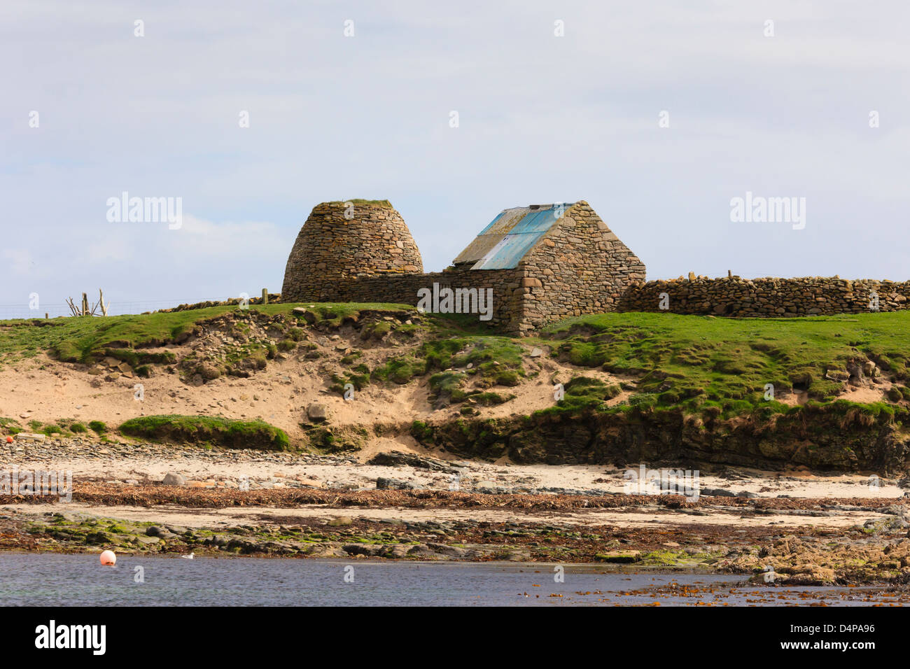 Offshore view of broch and stone building on Isle of Noss National ...