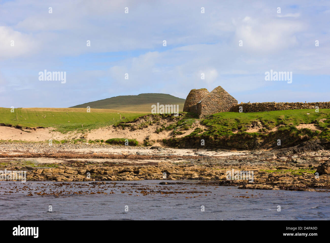Offshore view of broch and stone building on Isle of Noss National ...