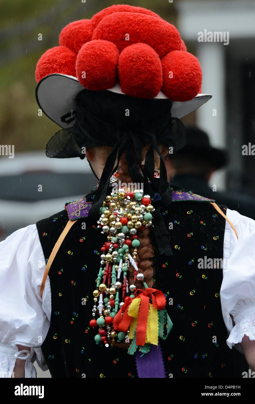 A member of the local folklore society wears traditional clothing as ...