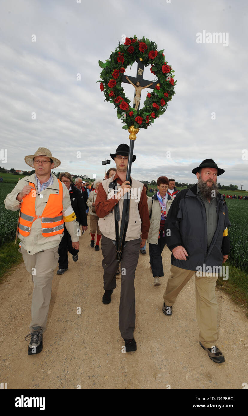 A pilgrim carries a cross at Germany?s largest pilgrimage in Regensburg ...