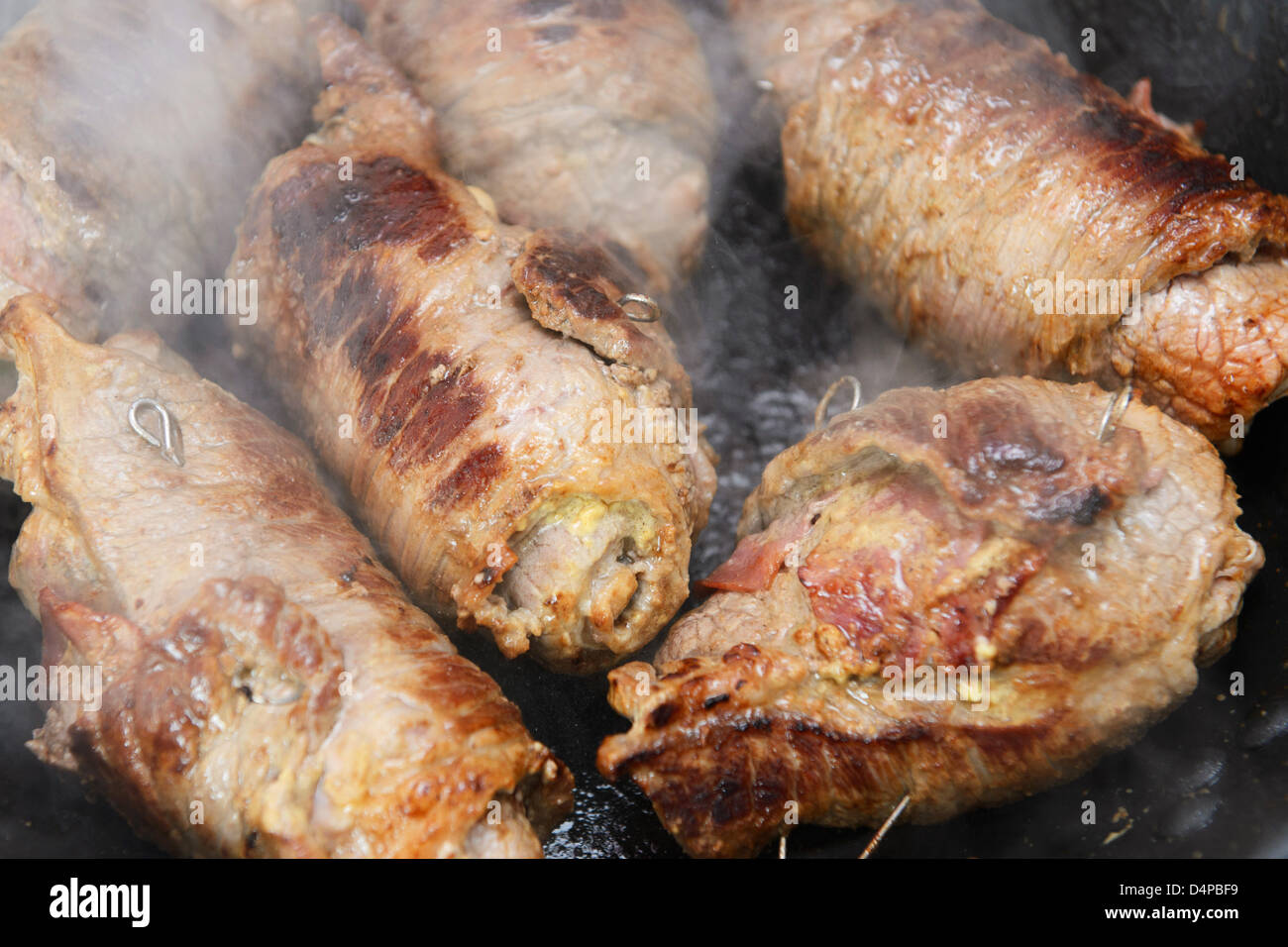 Beef wrapped with bacon, mustard, pickle and onion - beef rolls are ...