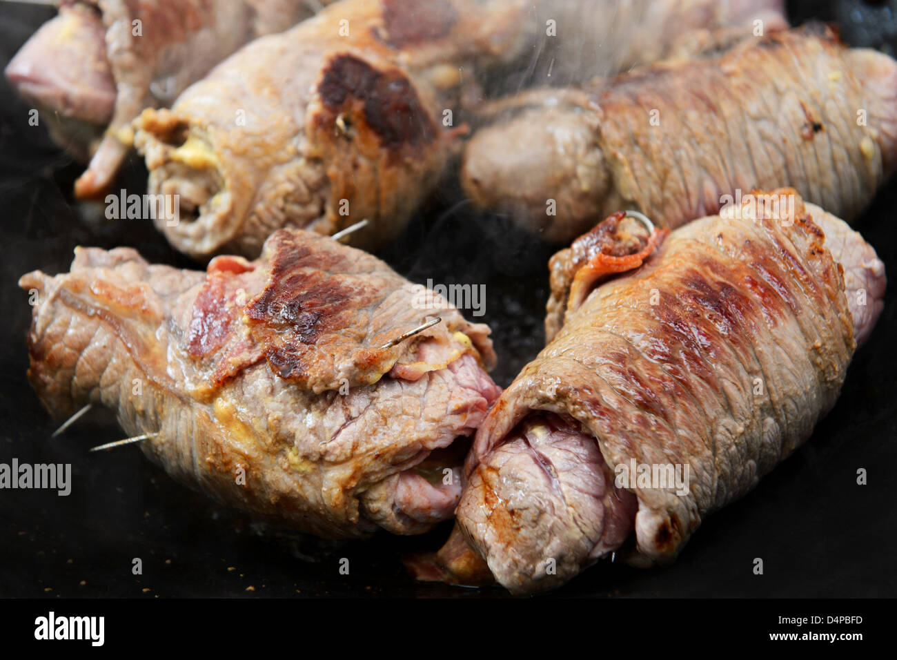 Beef wrapped with bacon, mustard, pickle and onion - beef rolls are ...