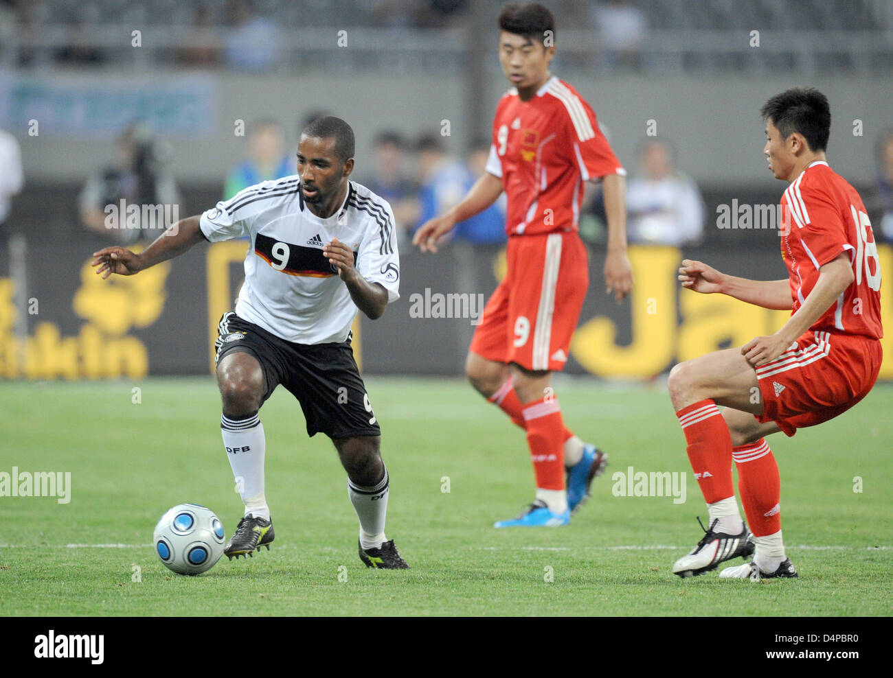 Germany?s Cacau (L) vies for the ball with China?s Han Peng (C) and ...