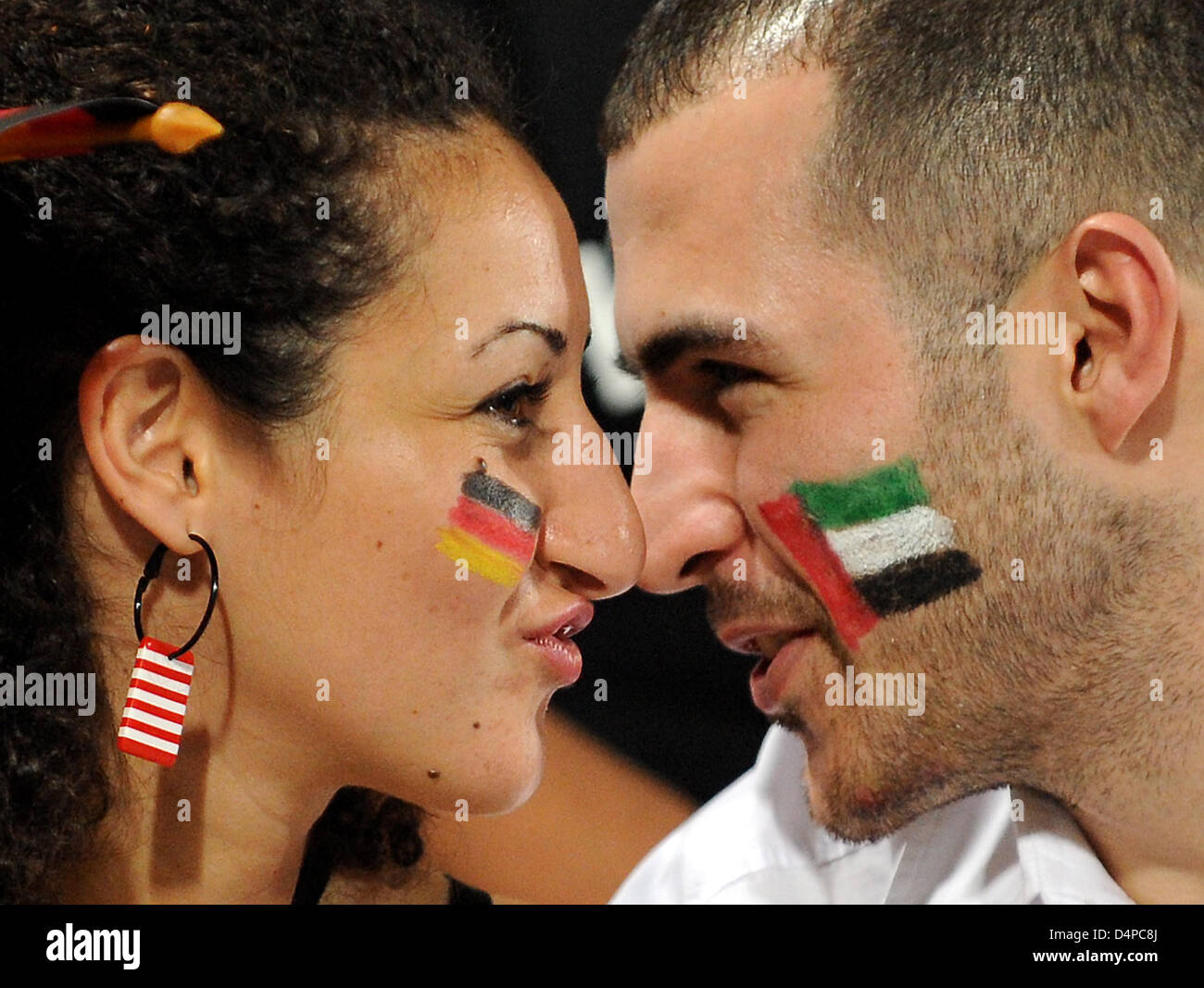 A woman and a man with the flags of Germany (L) and the United Arab ...