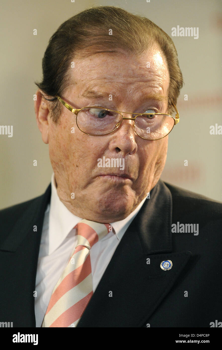 British actor and UNICEF ambassador Roger Moore makes a face as he ...