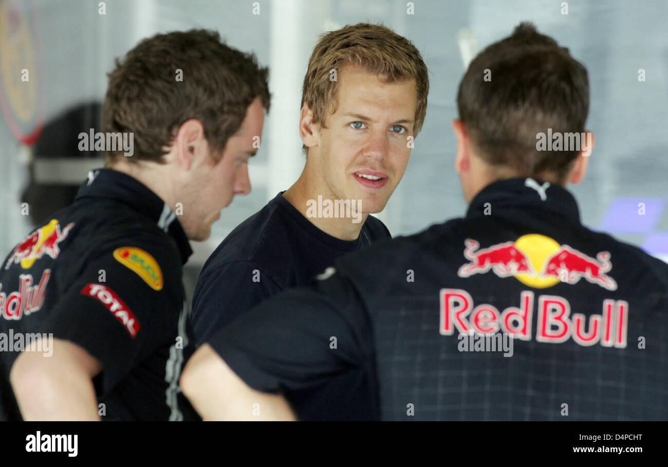 German Formula One driver Sebastian Vettel (C) of Red Bull Racing ...