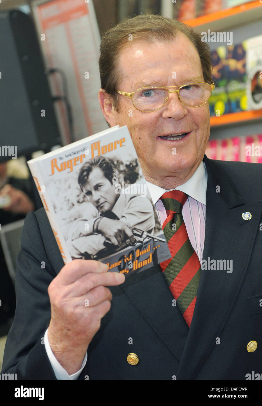 British actor and UNICEF Ambassador Roger Moore presents his ...
