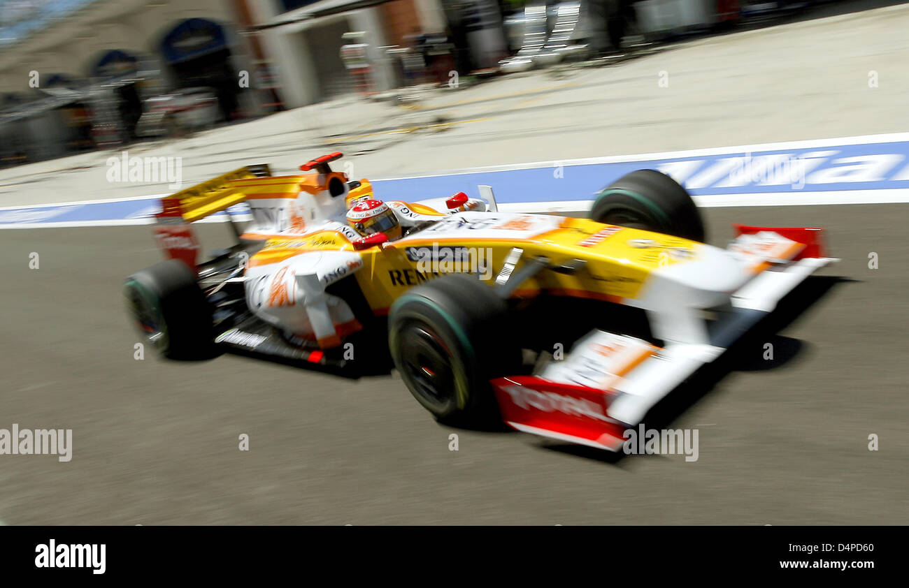 Spanish Formula One driver Fernando Alonso of Renault F1 Team steers his car through the pit ...