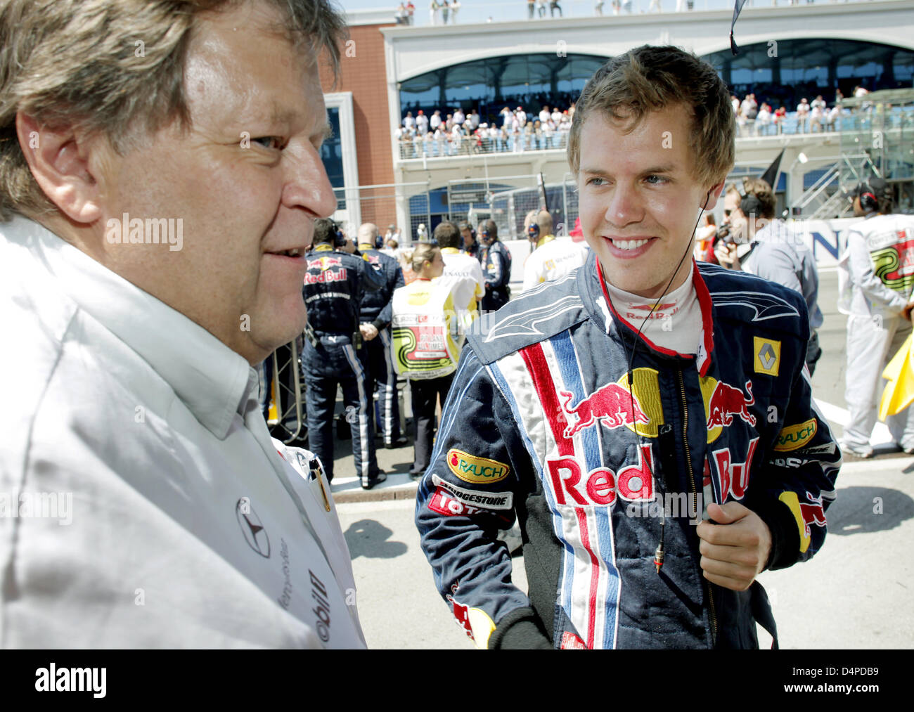 German Formula One driver Sebastian Vettel (R) of Red Bull Racing talks ...